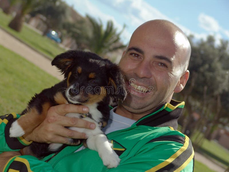 Man Holding Pet Dog stock photo. Image of sunshine, outdoors - 4696514