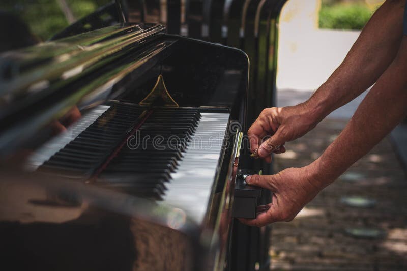 Man Holding a Piano Lock Key. Stock Photo - Image of performance ...