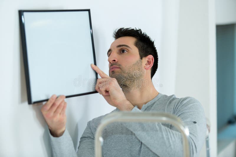 Man holding picture frame stock photo. Image of person - 313273912