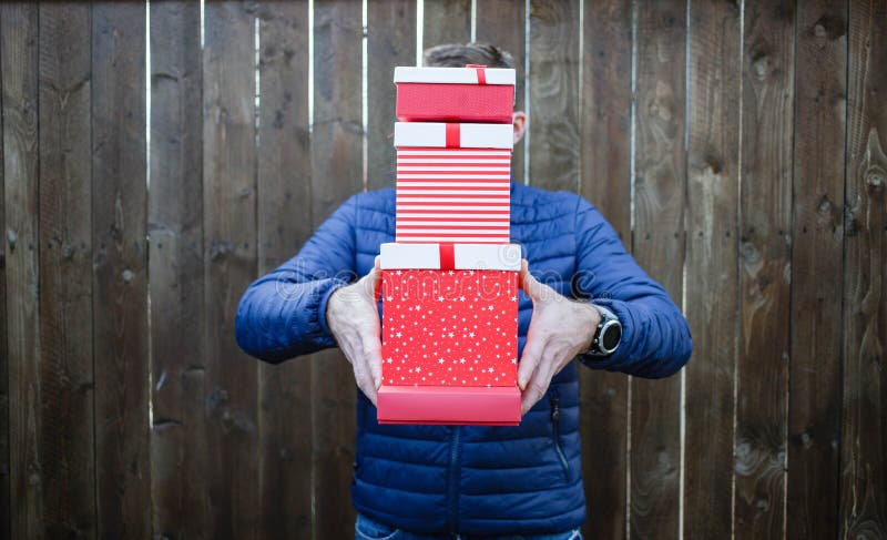 Man Holding Pile of Christmas Gift Boxes Stock Photo - Image of shopper ...