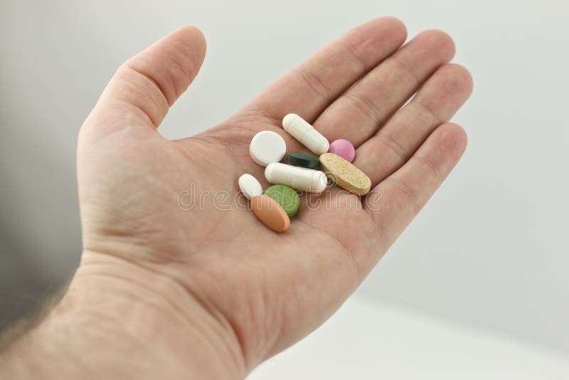 A Man Holding a Pill in His Hand Stock Photo - Image of person ...