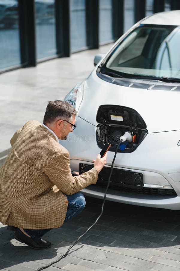 Man Holding Power Connector for Electric Car Stock Image - Image of ...