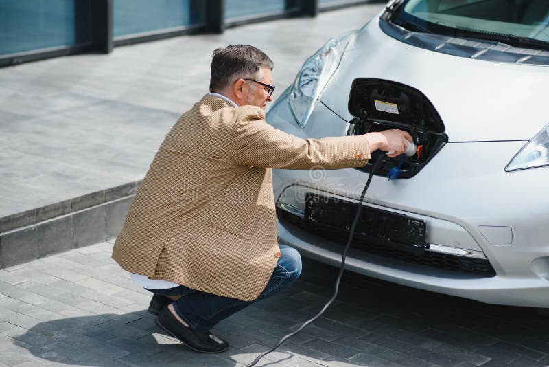Man Holding Power Connector for Electric Car Stock Image - Image of ...