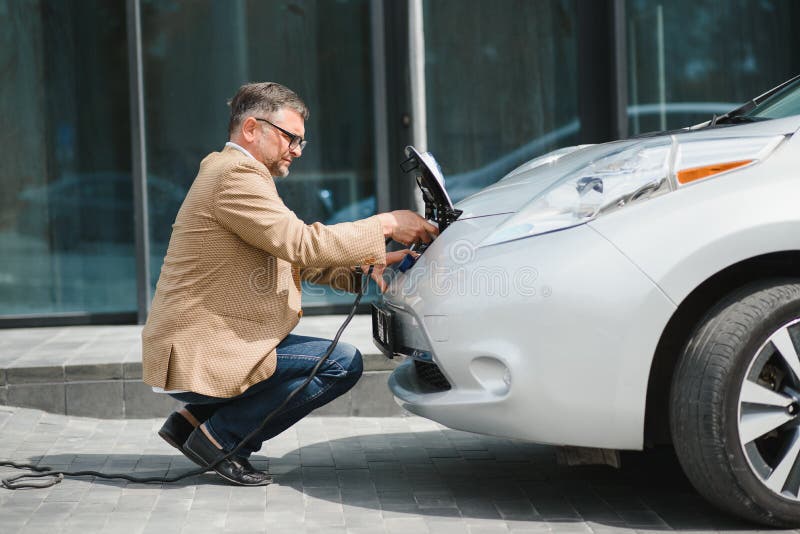 Man Holding Power Connector for Electric Car Stock Photo - Image of ...