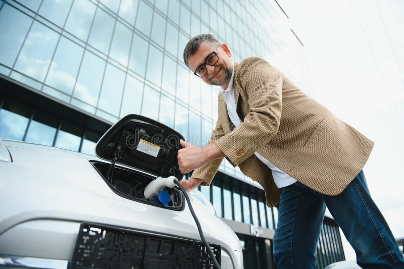 Man Holding Power Connector for Electric Car Stock Photo - Image of ...