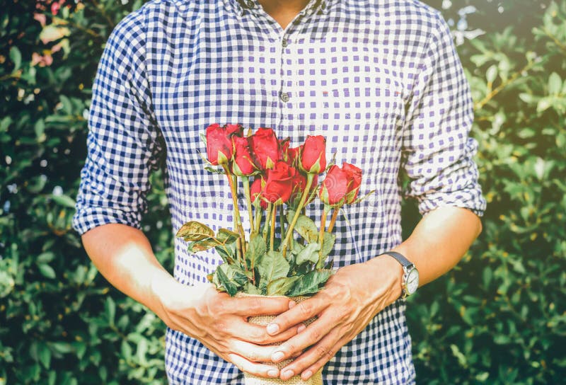 A Man Holding Red Roses in the Garden.Soft Focus Image. Stock Image ...