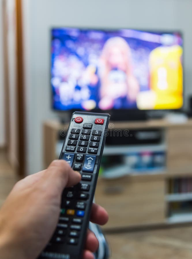 Man Holding a Remote Control Stock Photo - Image of match, room: 110695410