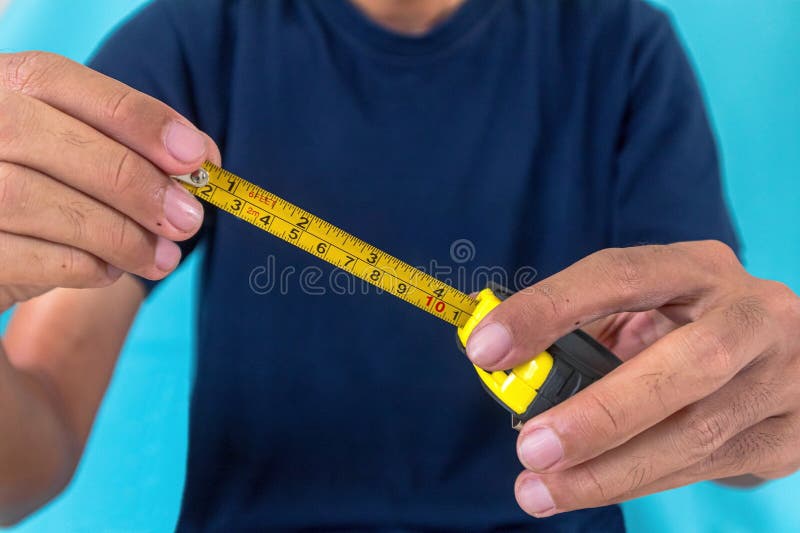 Man Holding a Roll Up Metal Tape Measure Stock Photo - Image of length ...