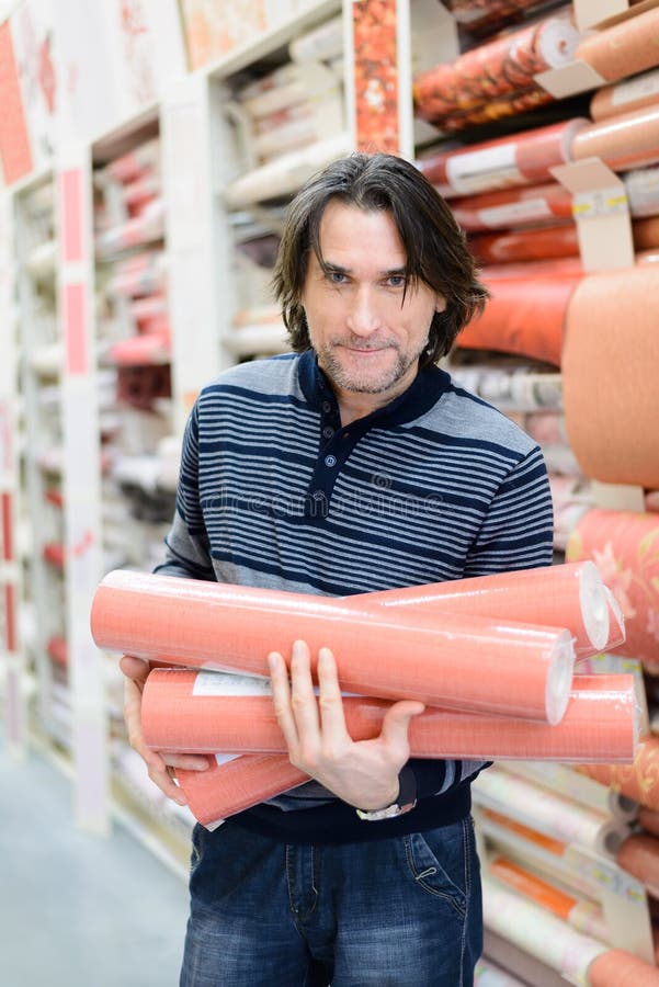 Man Holding a Roll of Wallpaper in the Store Stock Photo - Image of ...