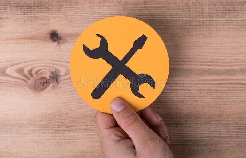 Man Holding a Round Orange Sign of Construction Tools Stock Photo ...