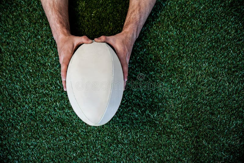 Man holding rugby ball stock photo. Image of professional - 60553520