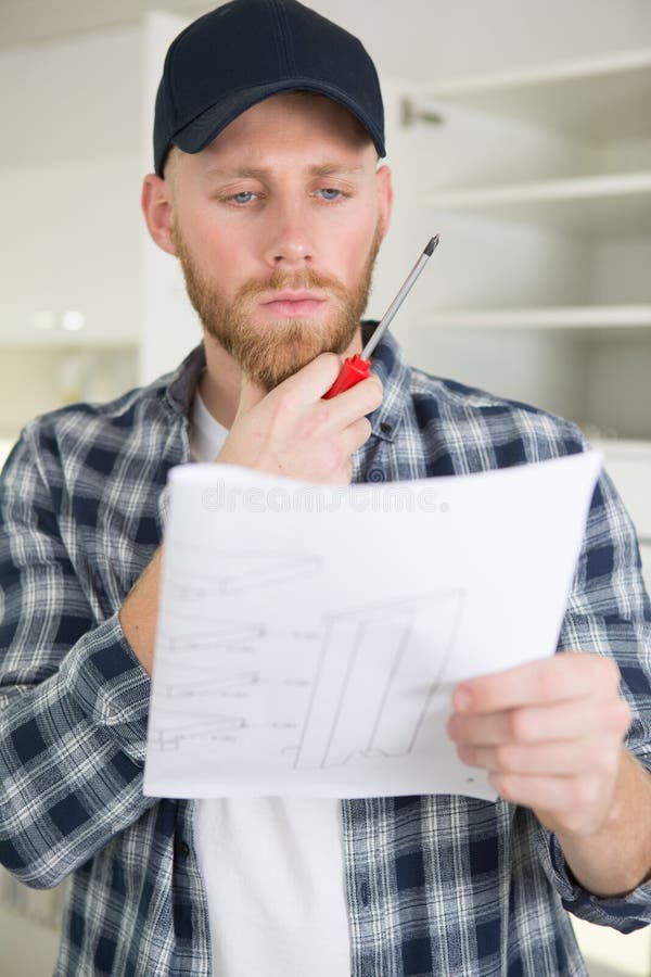 Man Reading Assembly Instructions for Flat Pack Stock Image - Image of ...