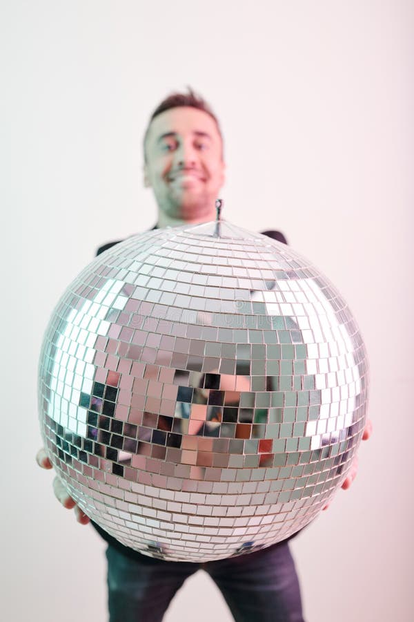 Man Holding Shiny Disco Ball Stock Image - Image of serious, people ...