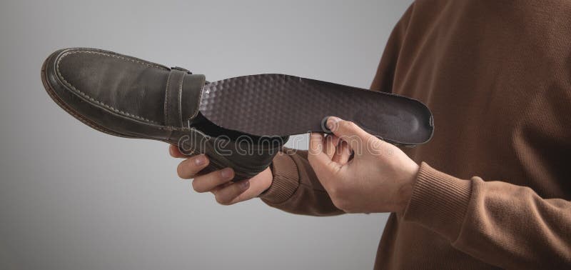 Man Holding Shoe with a Insole Stock Photo - Image of injury, health ...