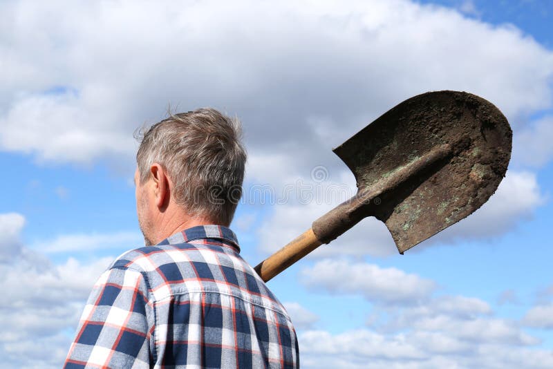 Man Holding Shovel Against Cloudy Sky, Back View. Digging Process Stock ...