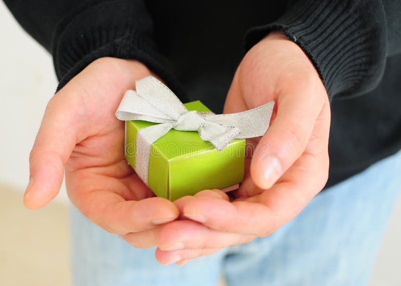 Man holding small present stock photo. Image of holidays - 16894802
