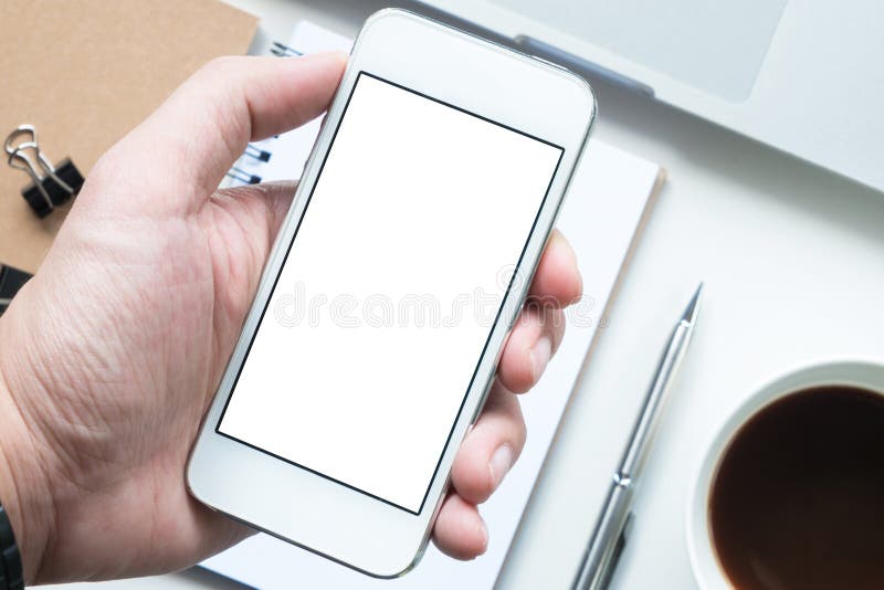Man Holding Smartphone with Blank Mockup Screen Over White Office Desk ...