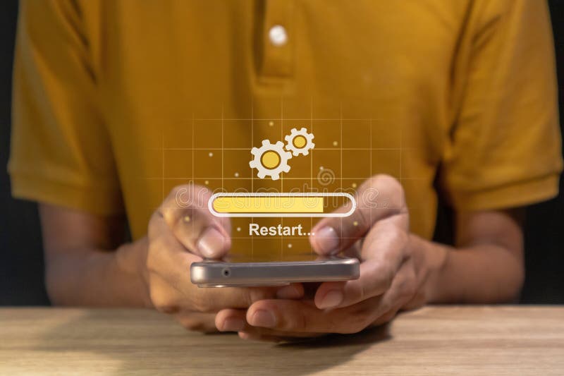 Man Holding a Smartphone with Operating System Being Restarted or ...