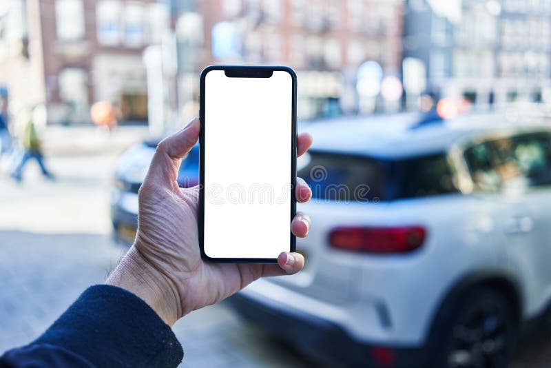 Man Holding Smartphone Showing White Blank Screen at Car Parking Stock ...