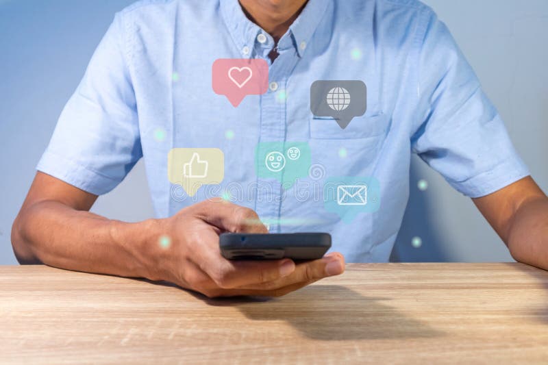A Man Holding a Smartphone To Open Social Media Applications Stock ...