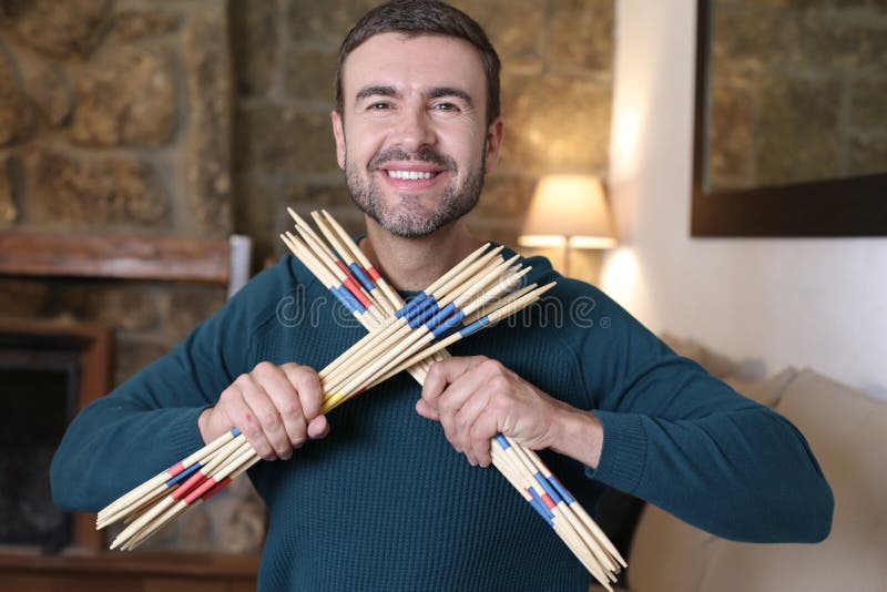 Man Holding Some Mikado Sticks Stock Image - Image of people, leisure ...