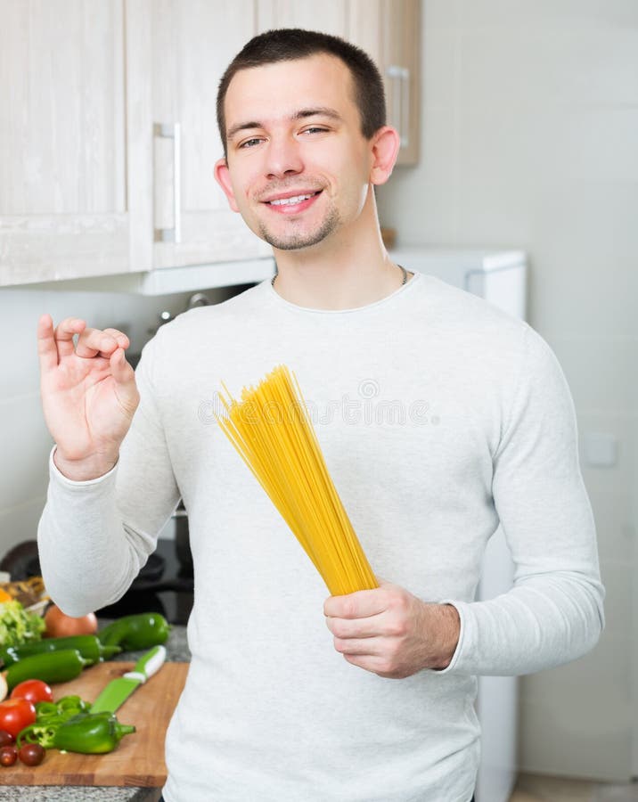 Man Holding Spaghetti at Kitchen Stock Image - Image of healthy, person ...