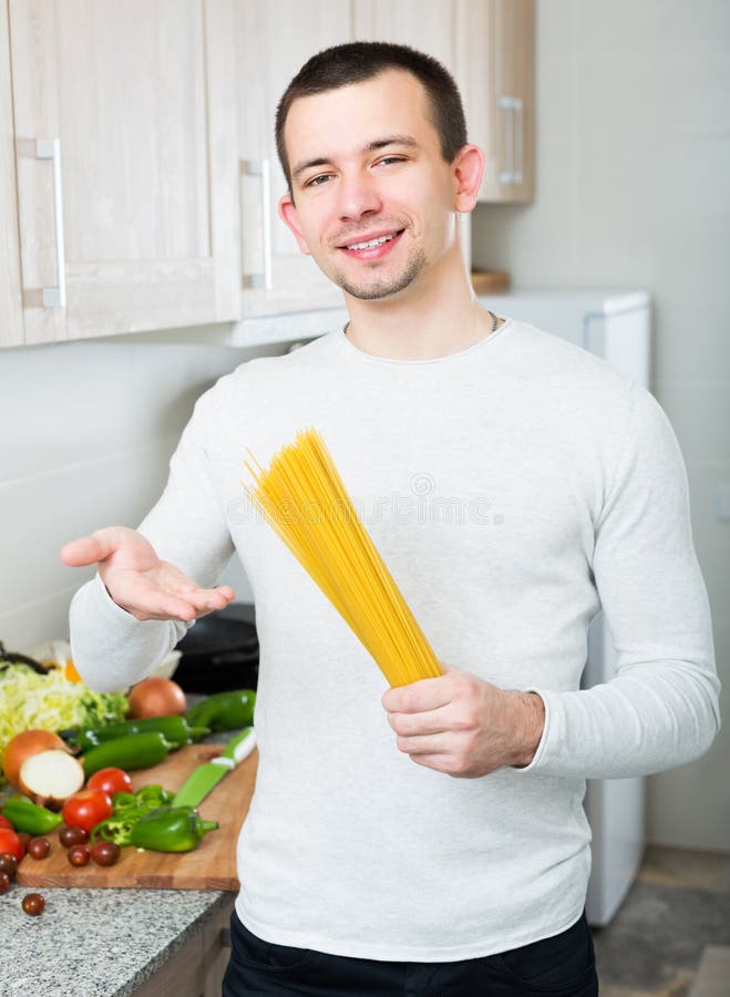 Man Holding Spaghetti at Kitchen Stock Image - Image of healthy, person ...