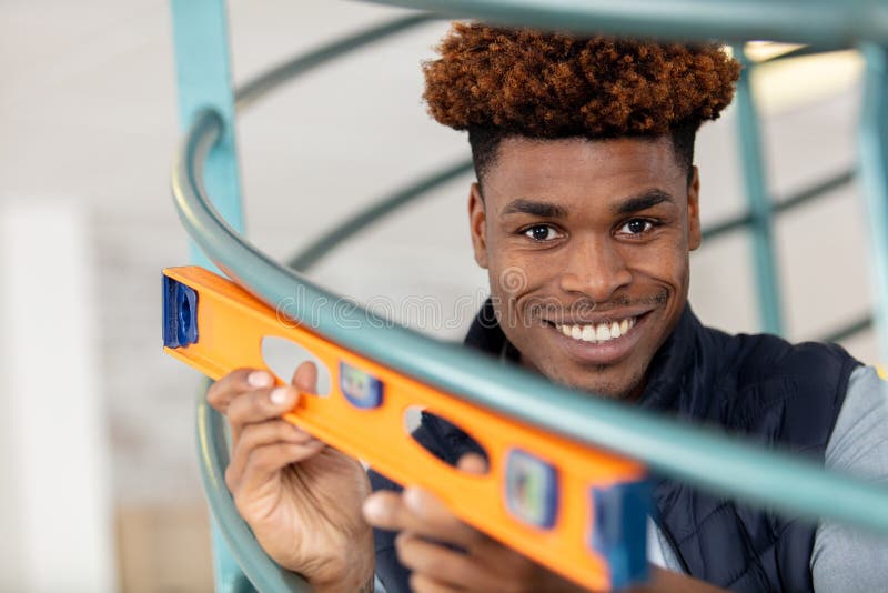 Man Holding Spirit Level Against Railing Stock Photo - Image of guide ...
