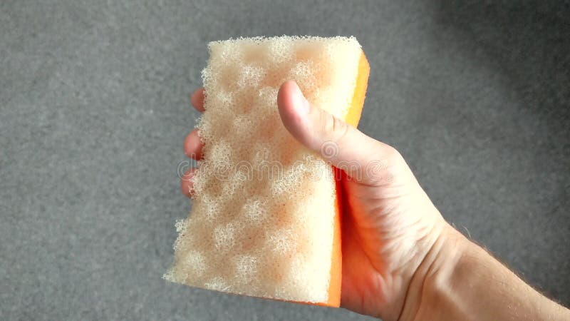 Man Holding a Sponge for Washing the Body in His Hand and Shows it ...