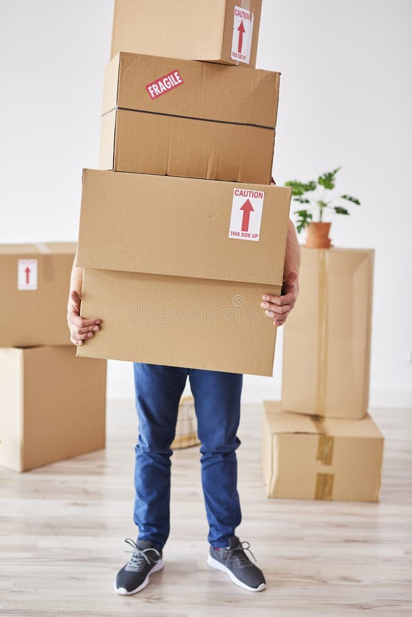 Man Holding Stack of Boxes in Front of His Face Stock Image - Image of ...