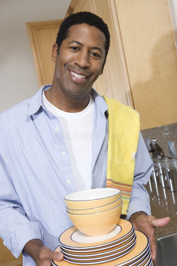 Man Holding Stack of Washed Plates Stock Photo - Image of interior ...