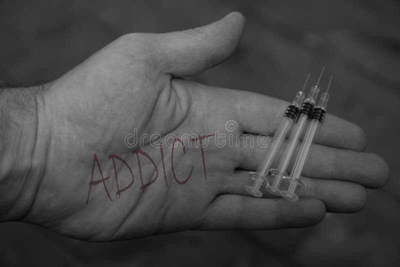 Man Holding Syringes Needles with the Word Addict Written on His Hands ...