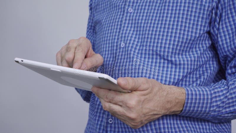 A Man Holding a Tablet Computer in His Hand Stock Photo - Image of ...