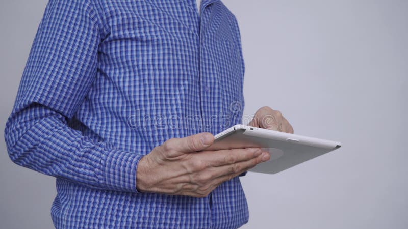 A Man Holding a Tablet Computer in His Hand Stock Photo - Image of ...
