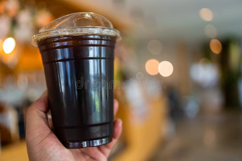 Man Holding a Take Out Iced Black Coffee at Coffee Shop Stock Photo ...