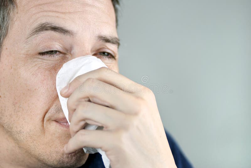 Man Holding Tissue on Nose stock photo. Image of contagious - 18985784