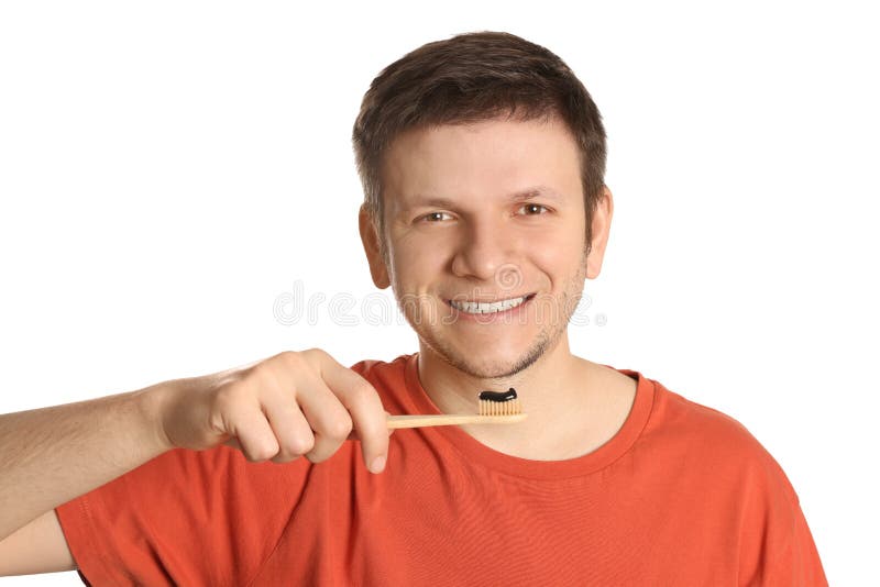 Man Holding Toothbrush with Charcoal Toothpaste on White Background ...