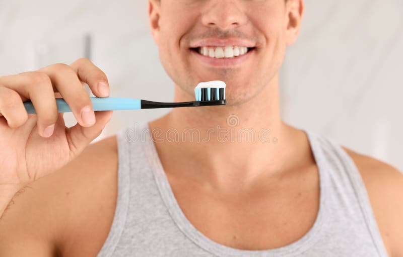 Man Holding Toothbrush with Paste Indoors, Closeup Stock Image - Image ...