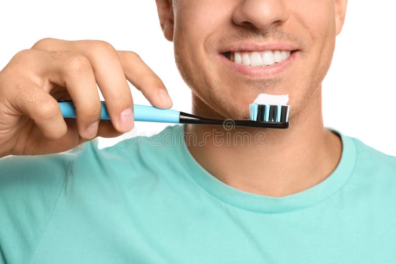 Man Holding Toothbrush with Paste on White Background, Closeup Stock ...