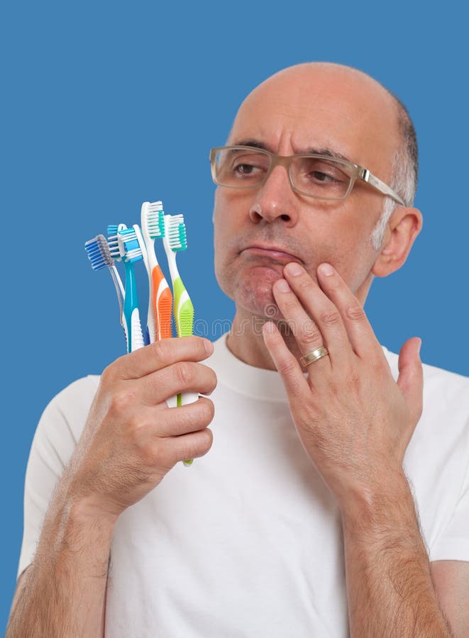Man holding toothbrushes stock image. Image of caucasian - 63479261
