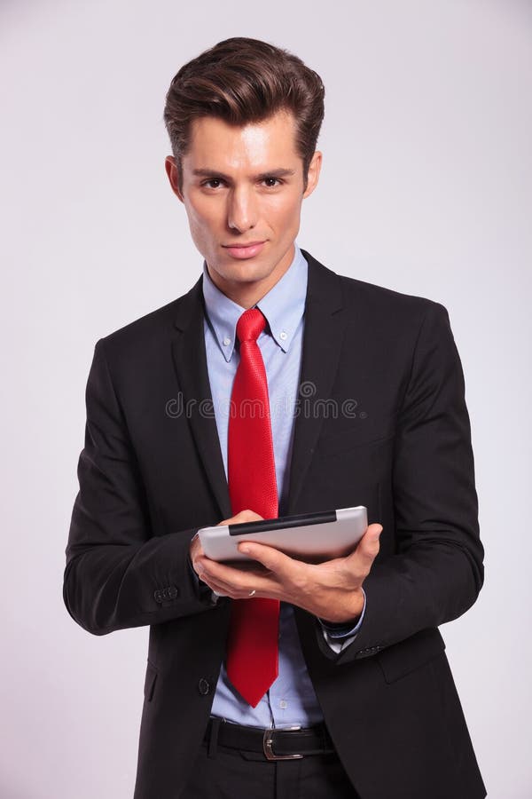Man Holding Touch Pad & Smiling Stock Image - Image of grey, technology ...
