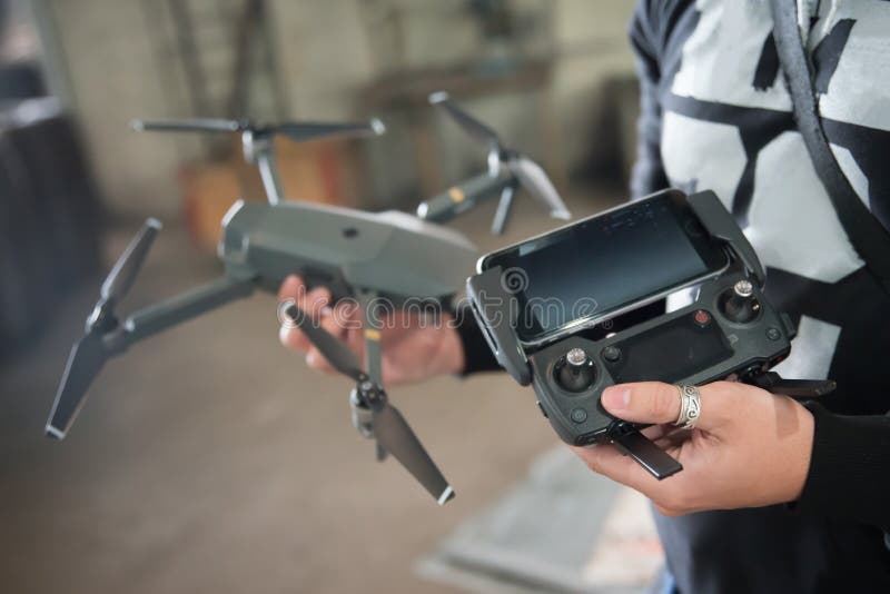 Man Holding Transmitter with Attached Mobile Device and Drone Stock ...