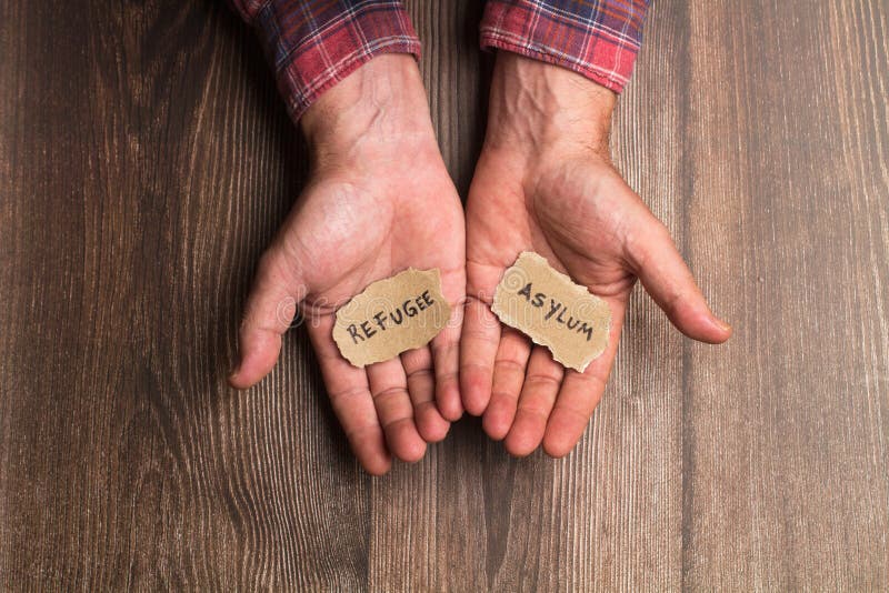 Man Holding Two Pieces of Paper with Refugee and Asylum Write in Them ...