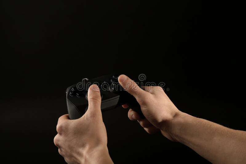 Man Holding Video Game Controller on Black, Closeup Stock Photo - Image ...