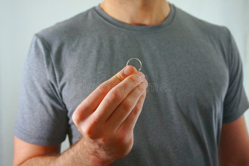 Man Holding Wedding Ring stock photo. Image of close - 59150652