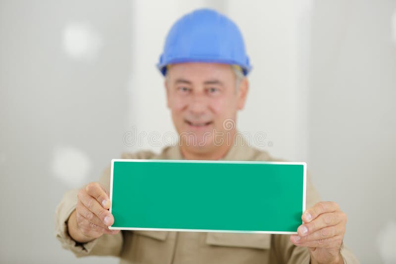 Man holding wet paint sign stock photo. Image of banner - 186144296