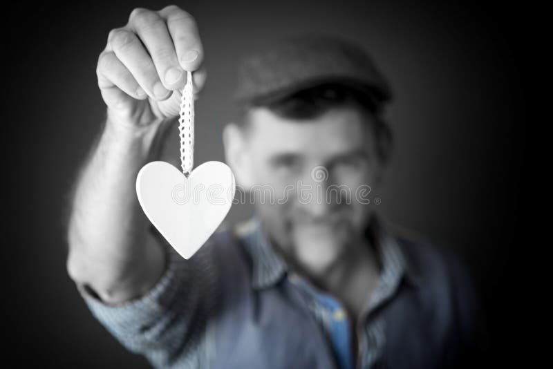 Man Holding White Wooden Heart on a String Stock Image - Image of ...