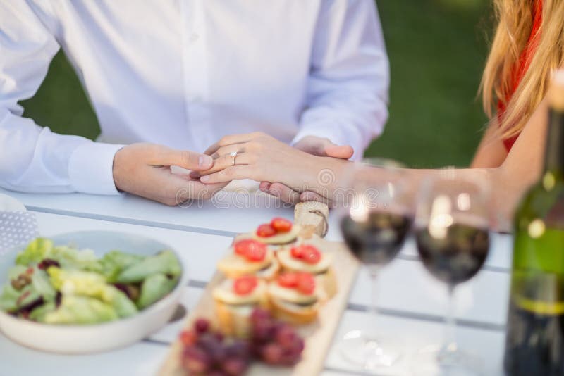 Man Holding Womans Hand in the Restaurant Stock Image - Image of date ...