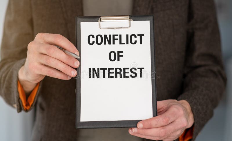 A Man Holds a Clipboard with the Word Conflict of Interest Written on ...