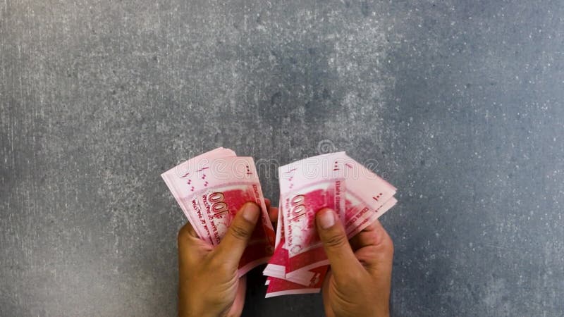 A Man Holds and Counting One Hundred Rupees Notes in His Hands Stock ...